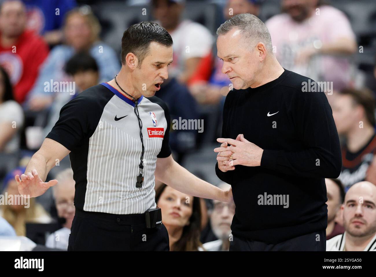 Referee Kevin Scott talks to Denver Nuggets head coach Michael Malone ...