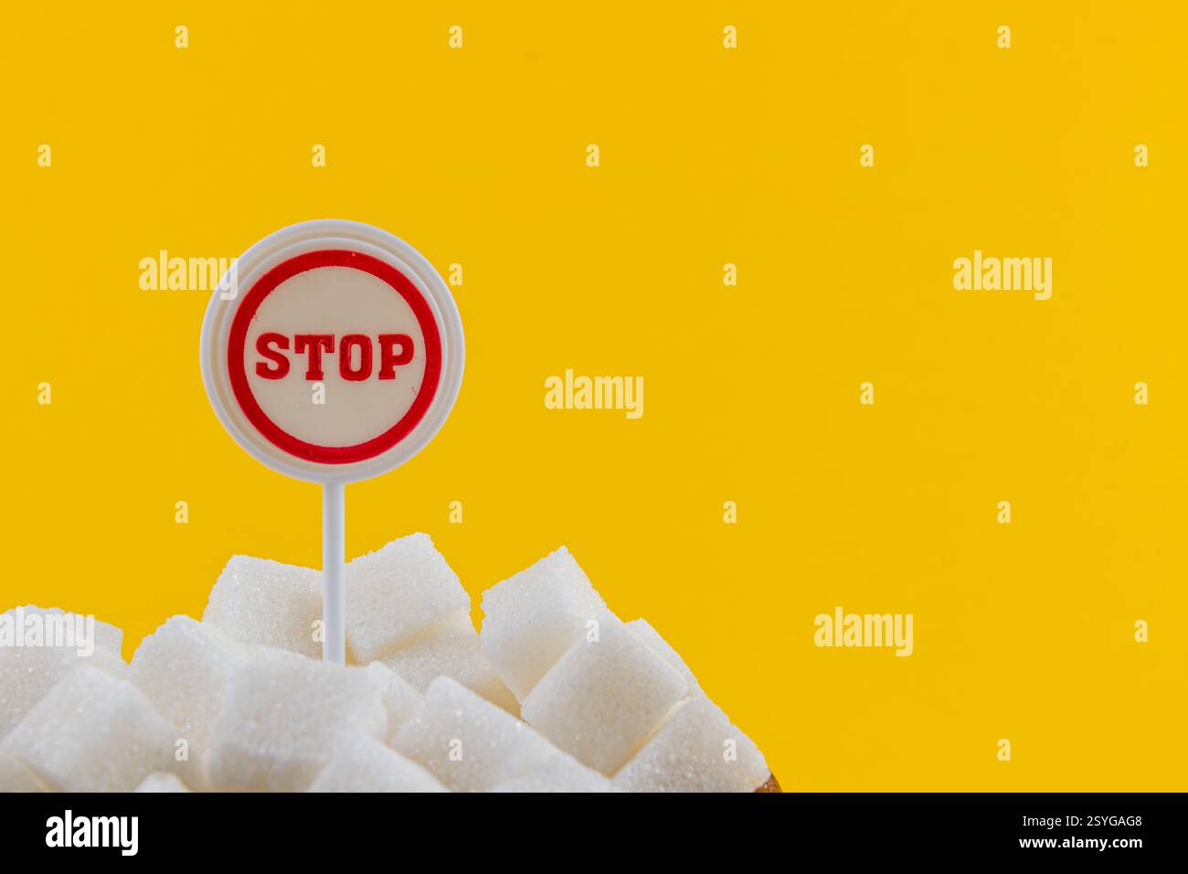 A creative display features a bold stop sign amidst piles of sugar ...