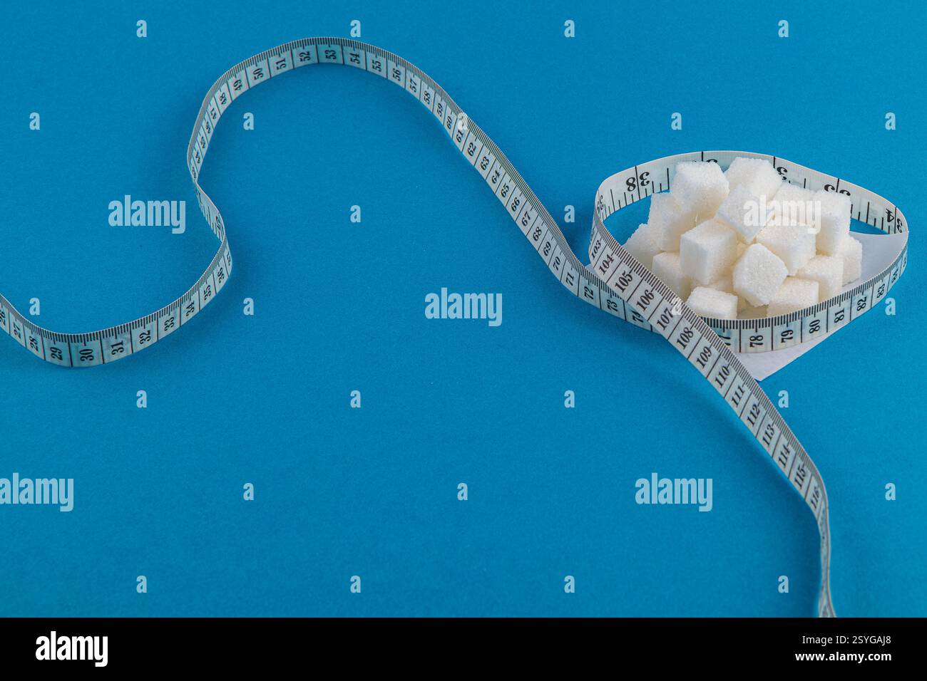 White sugar cubes are arranged in a heart-shaped bowl accompanied by a ...