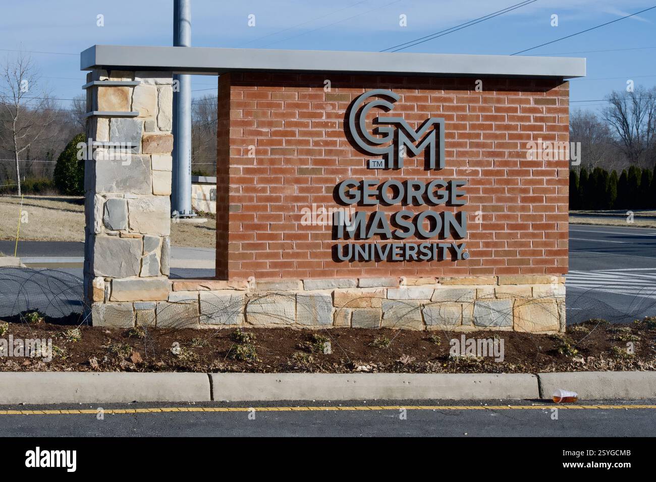 Fairfax, Virginia, USA - February 28, 2025: A brick sign at an entrance ...