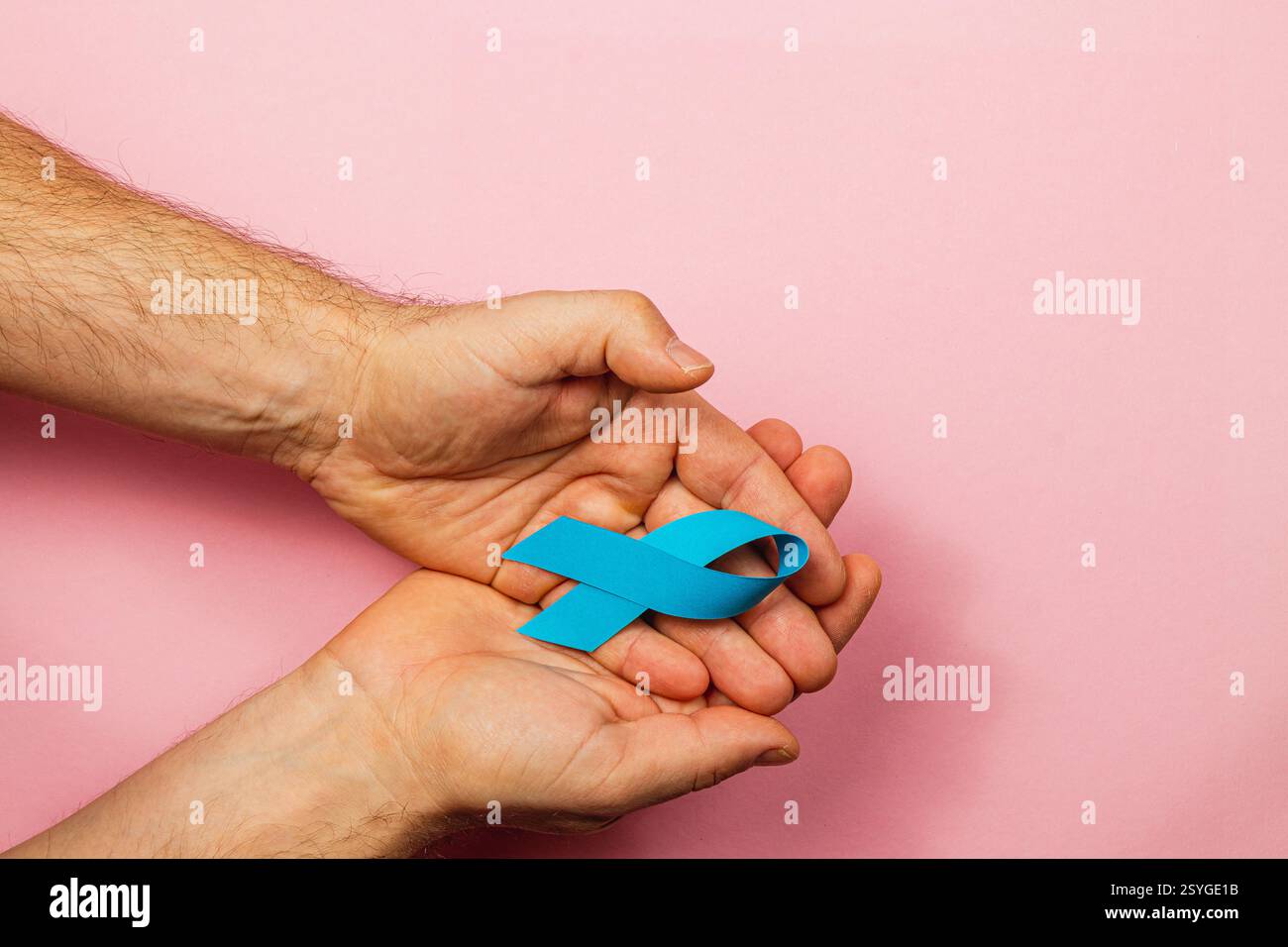 A male's hands gently hold a blue ribbon, representing a campaign for ...