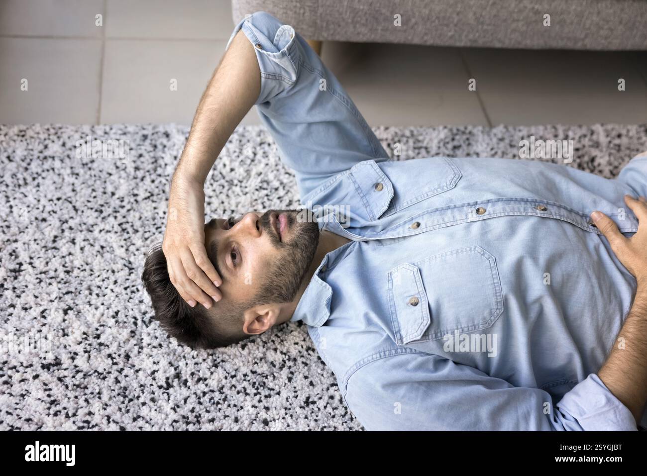 Moody young man lying on floor hi-res stock photography and images - Alamy