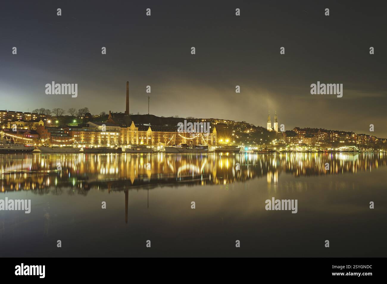 Shore view with lights and reflections at night, winter, ice, capital ...