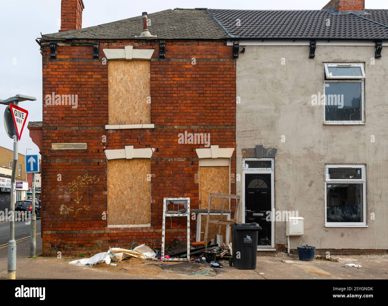 Derelict empty boarded-up house next to renovated house, Willingham ...