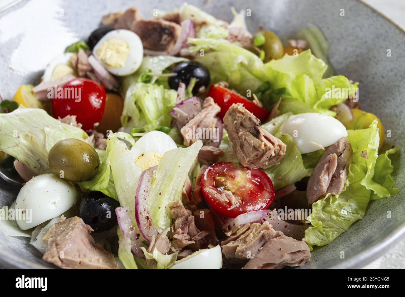 Salad with canned tuna, vegetable salad with quail eggs, lettuce, red ...