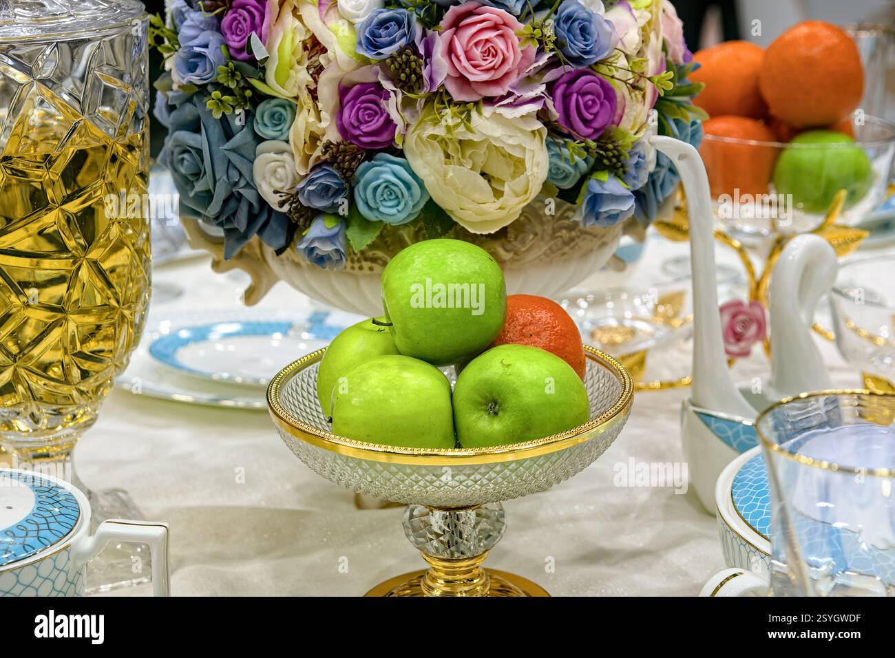 Fresh fruits in glass vase on festively decorated table Stock Photo - Alamy