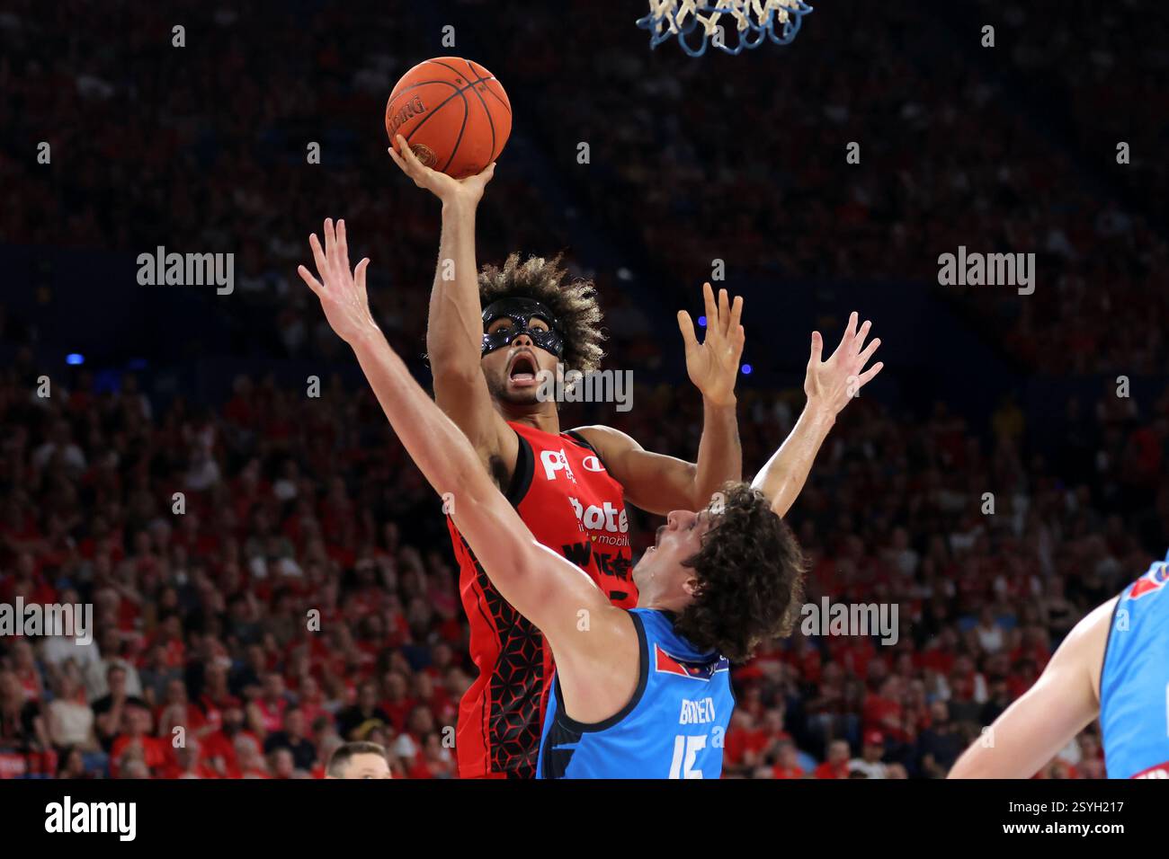 Keanu Pinder of the Wildcats puts up a shot under pressure from Kyle ...
