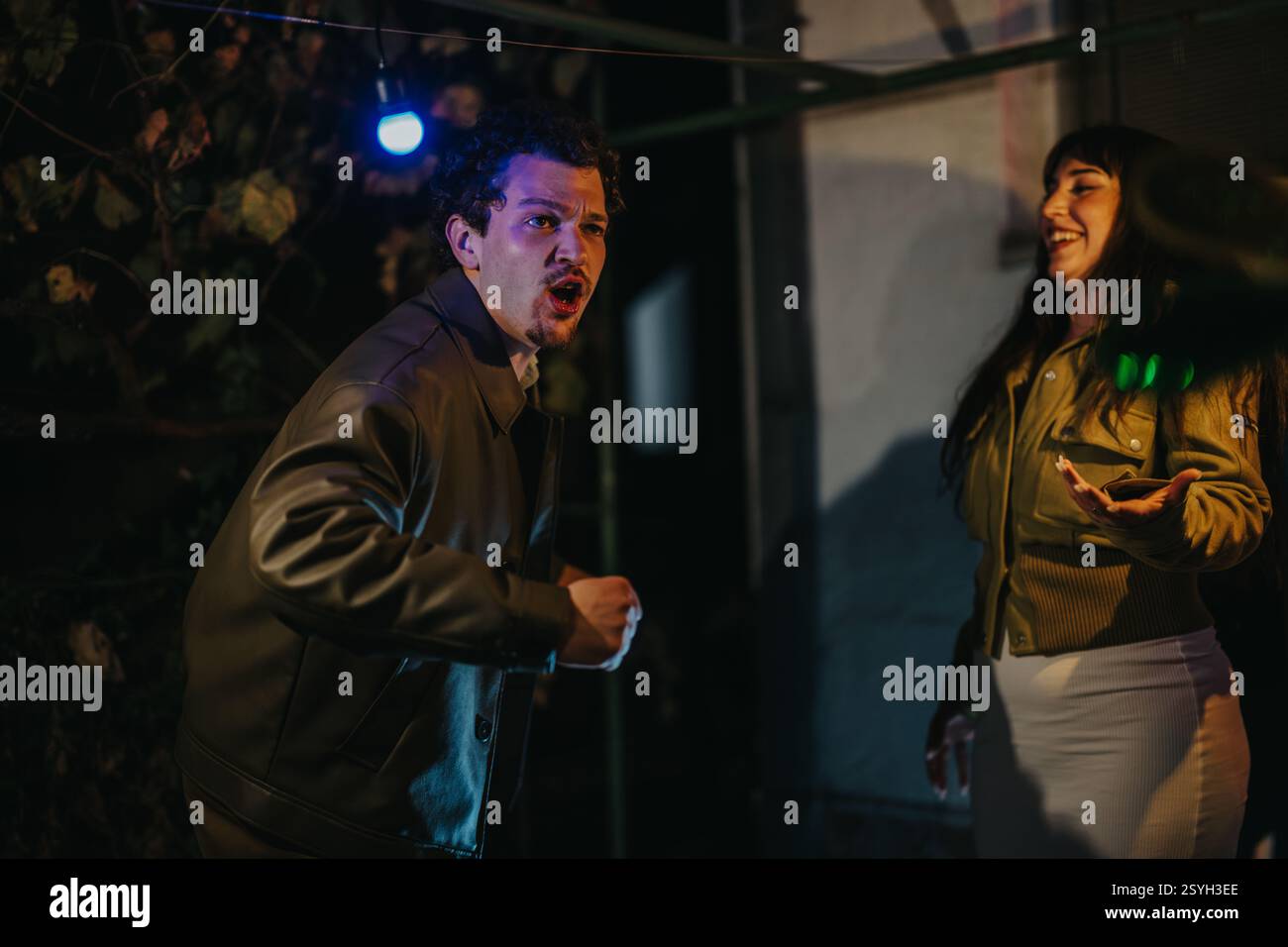 Two people sharing an emotional moment during an evening gathering ...