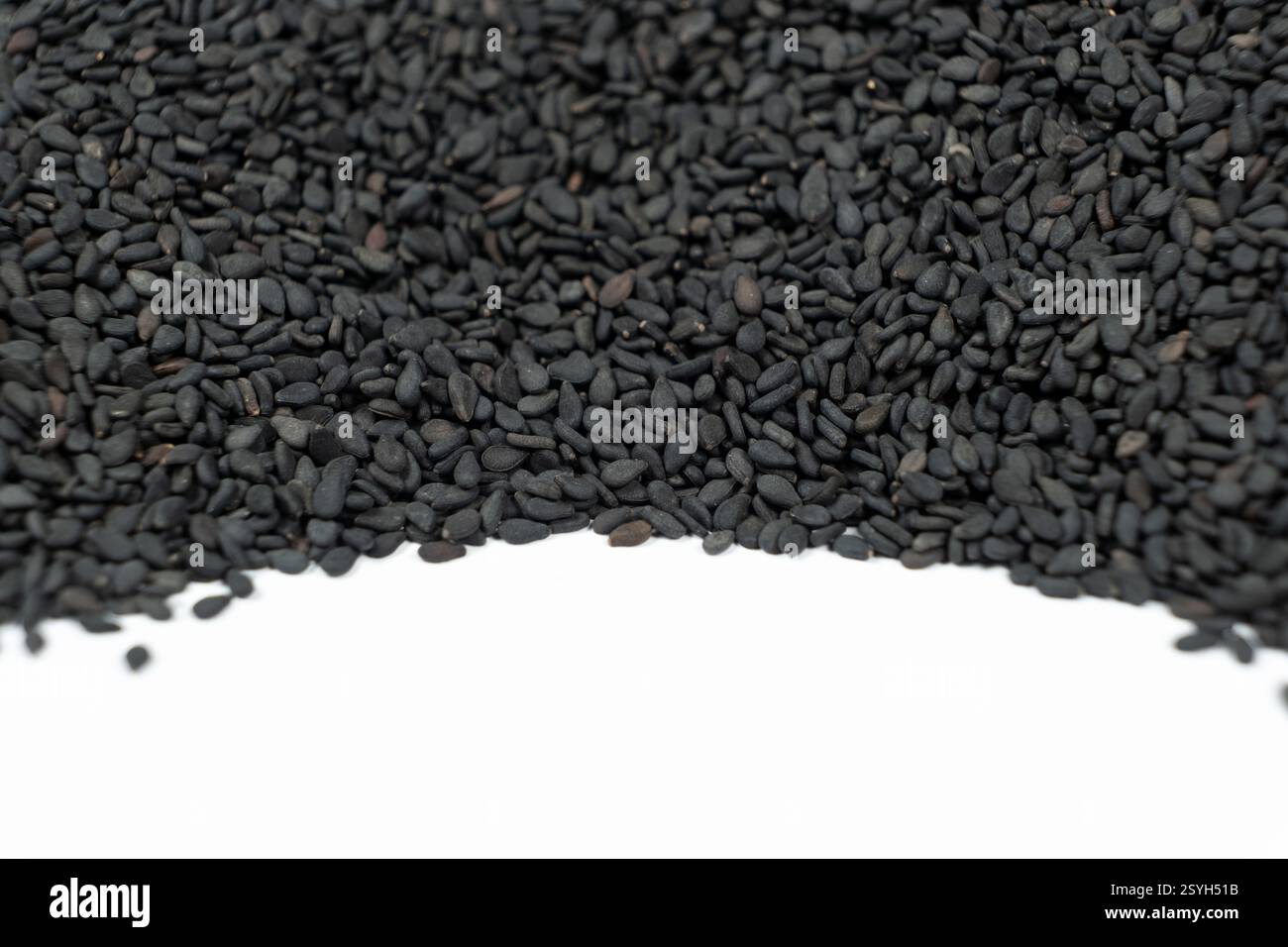 Black sesame seeds scattered on a white background place for text Stock ...