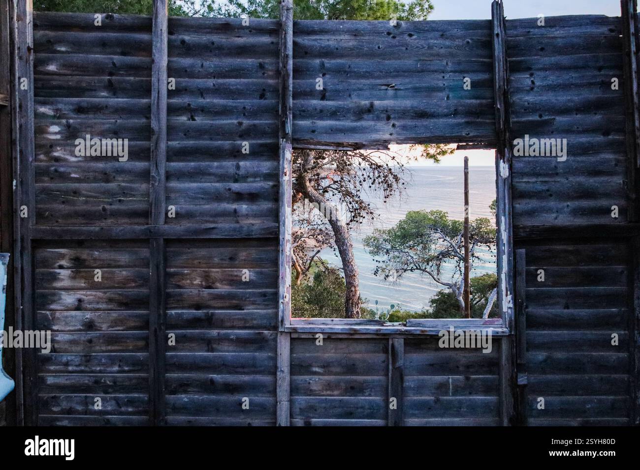 Broken Window Frame on dilapidated wooden wall of an abandoned shack ...