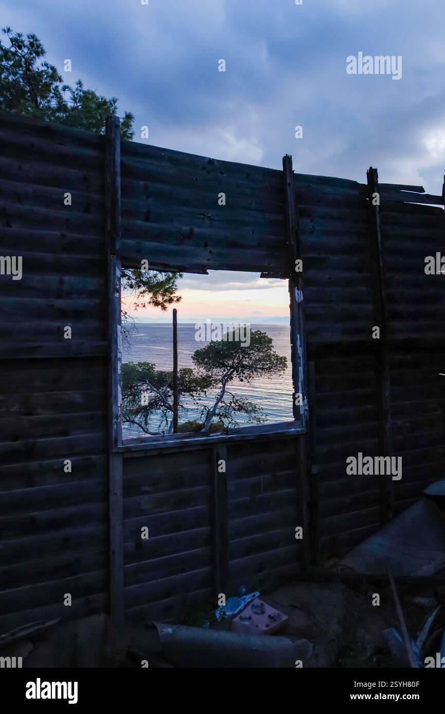 Broken Window Frame on dilapidated wooden wall of an abandoned shack ...