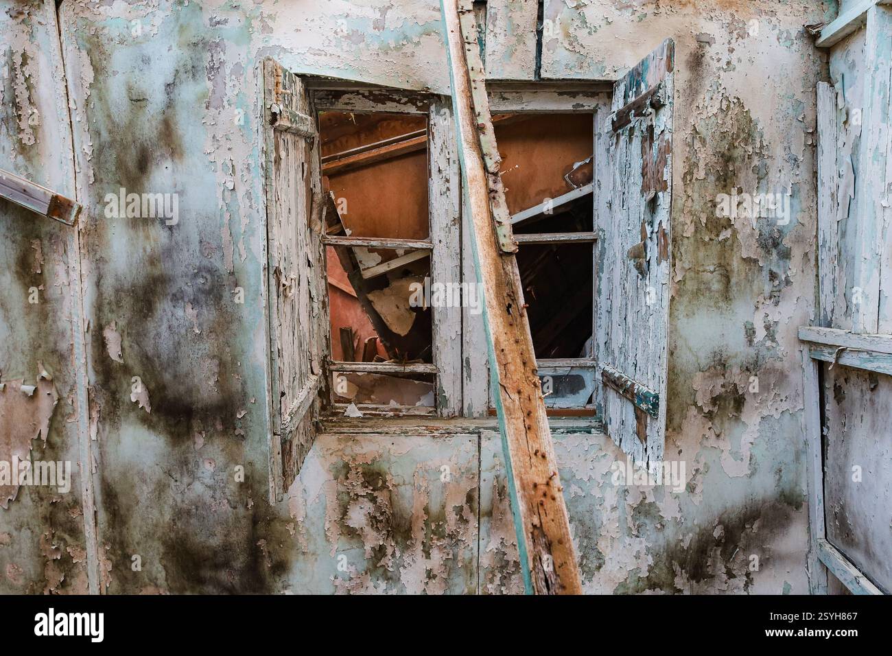 Broken Window Frame on dilapidated wooden wall of an abandoned shack ...