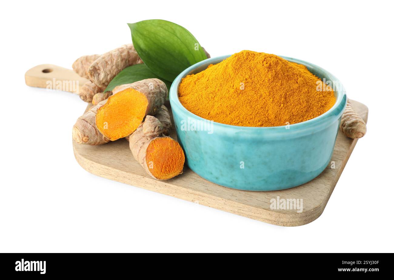 Turmeric powder in bowl, roots and green leaves isolated on white Stock ...