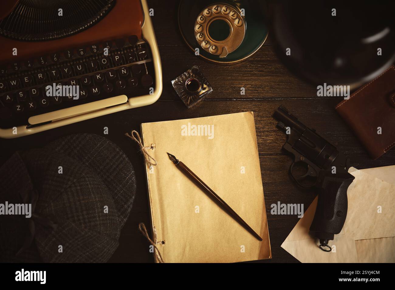 Typewriter, hat, paper, fountain pen and gun on detective's desk, flat ...