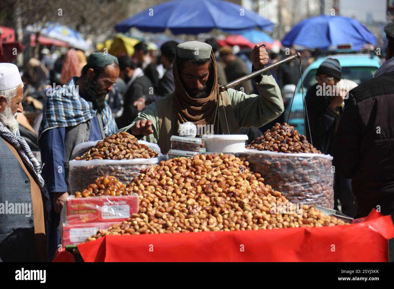 Kabul, Afghanistan. 1st Mar, 2025. A street vendor sells dates on the ...