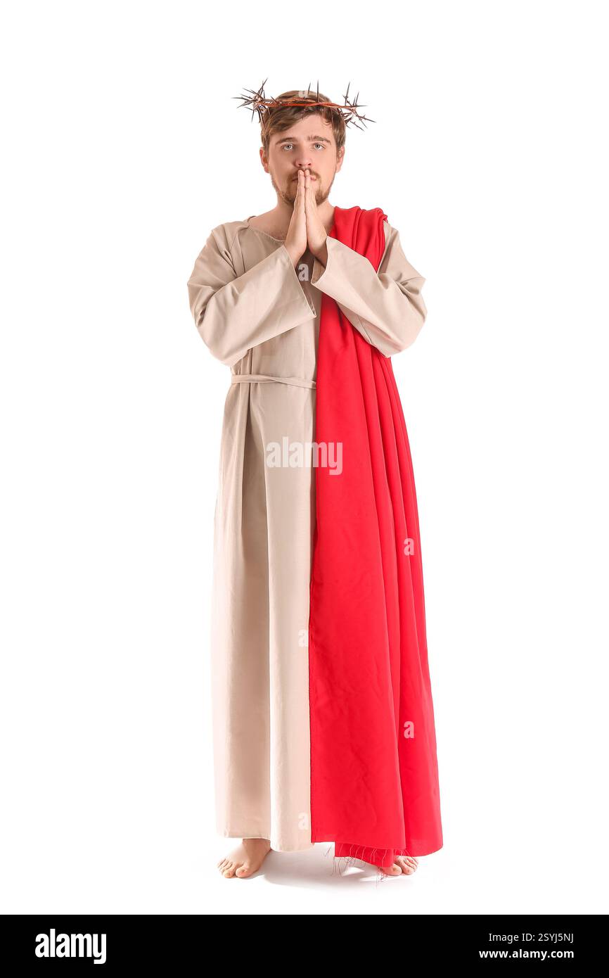 Man in Jesus robe and crown of thorns praying on white background Stock ...