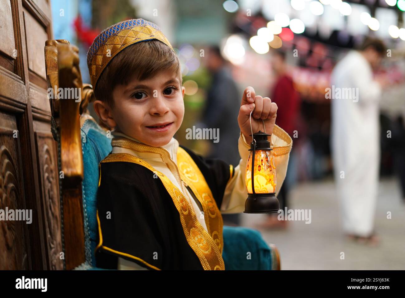 Mosul, Iraq. 28th Feb, 2025. A boy holds a traditional lantern known in ...