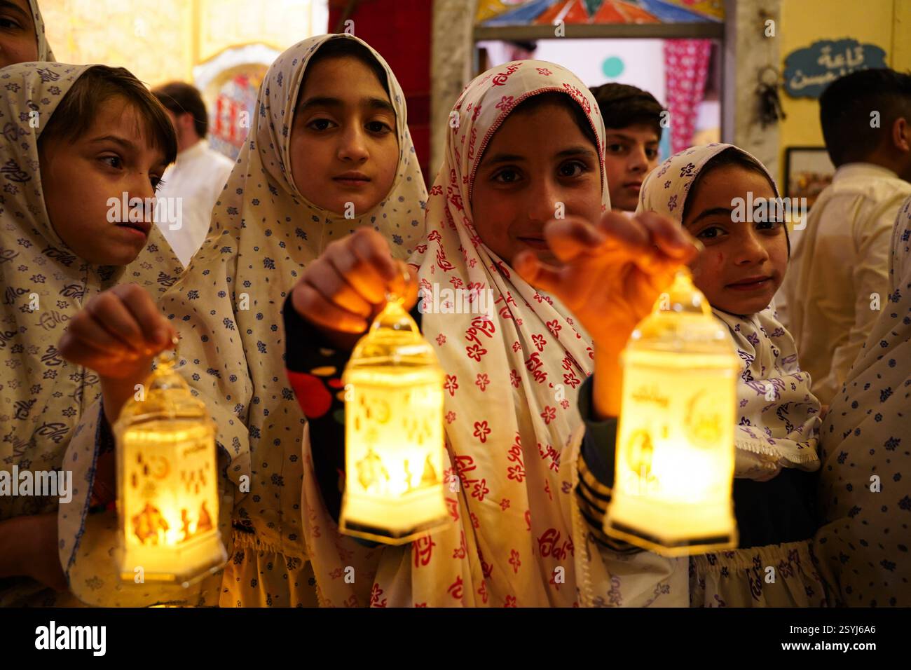 Mosul, Iraq. 28th Feb, 2025. Girls hold traditional lanterns known in ...