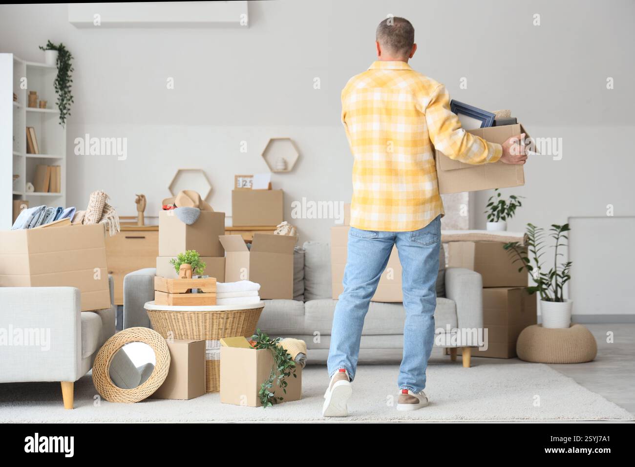 Mature man carrying box with things in his new flat, back view Stock ...