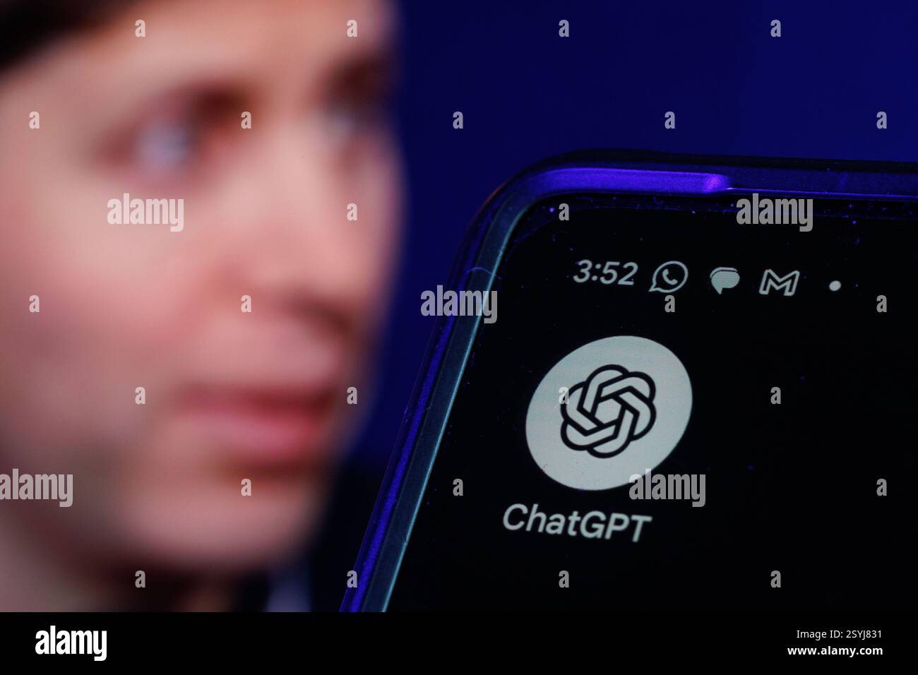 Artificial intelligence (AI) app logo of ChatGPT is seen on a smartphone screen. in front of the ...