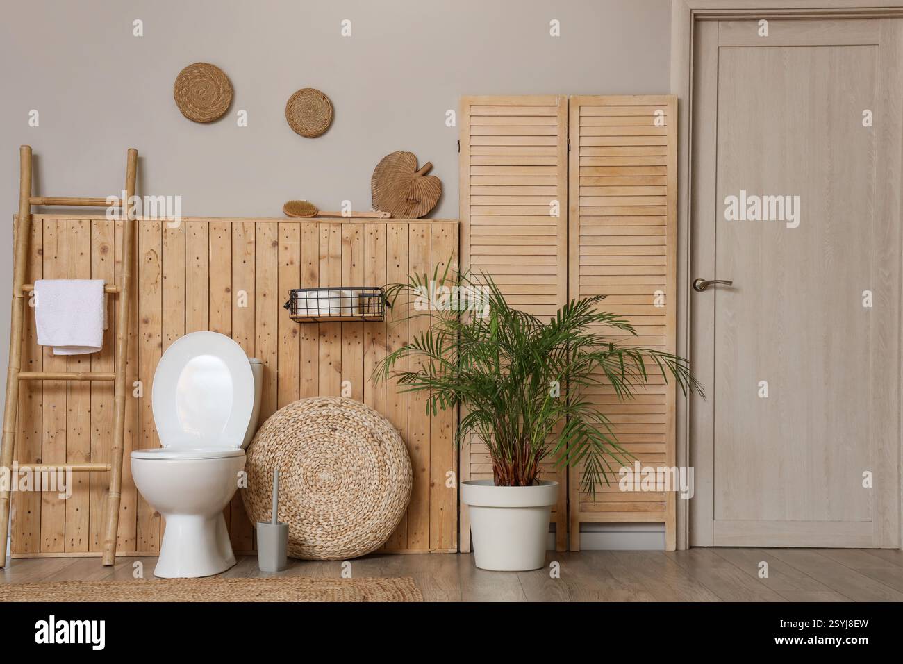 Interior of restroom with toilet bowl, ladder and palm tree Stock Photo ...