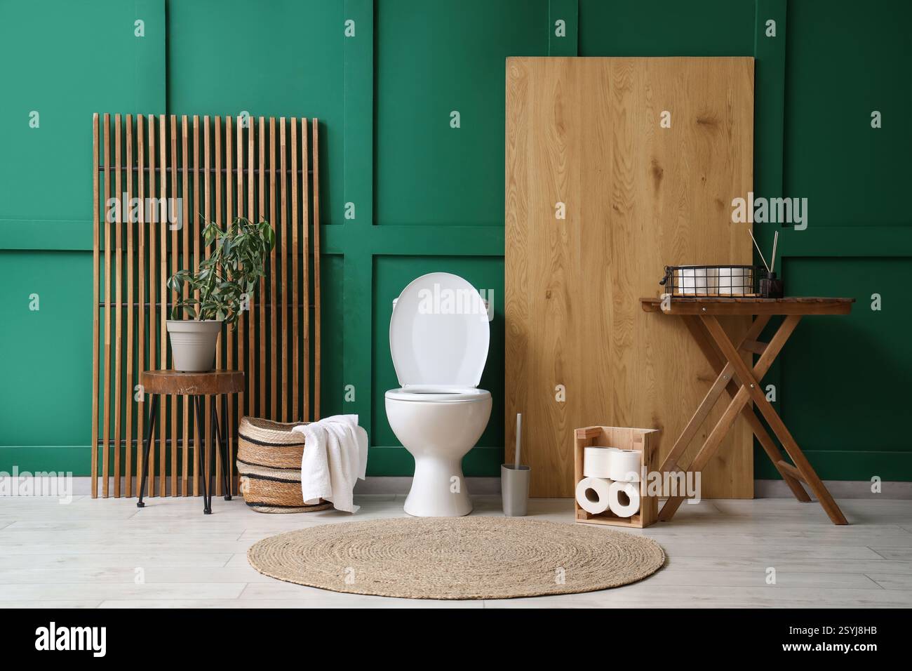 Interior of restroom with toilet bowl, tables and folding screen Stock ...