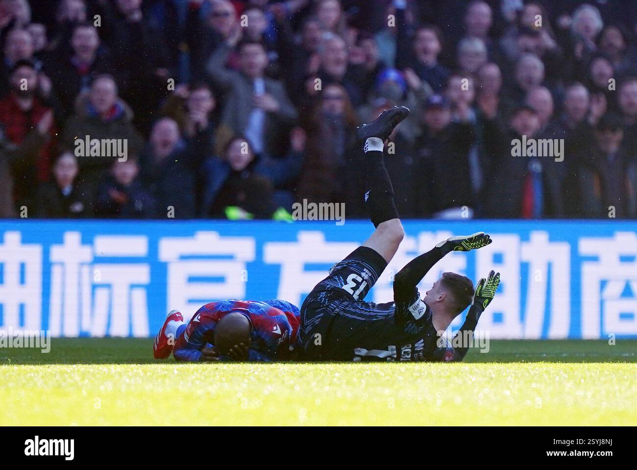 Millwall goalkeeper Liam Roberts clashes with Crystal Palace's Jean ...