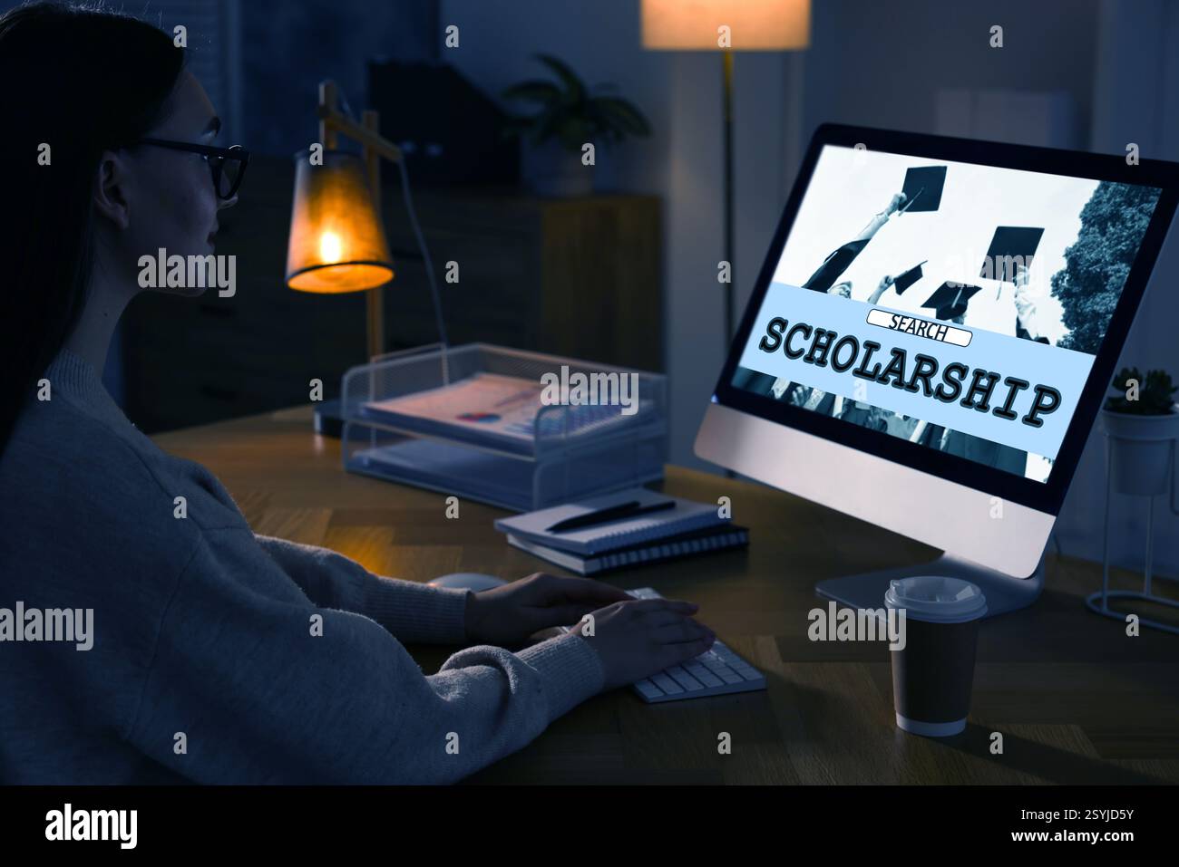 Student searching for scholarships using computer at home. Open website ...