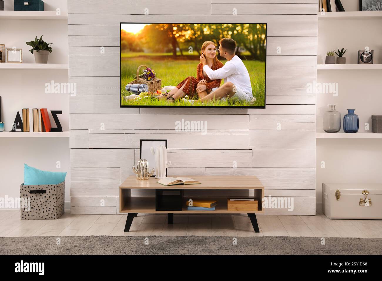 Movie playing on TV set in room Stock Photo - Alamy