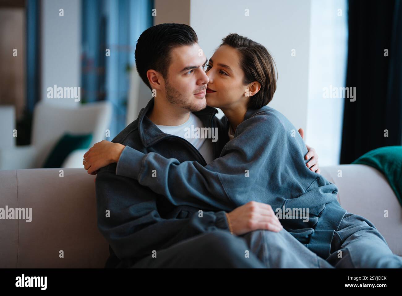 Cozy couple enjoying intimate moment in modern living room during ...