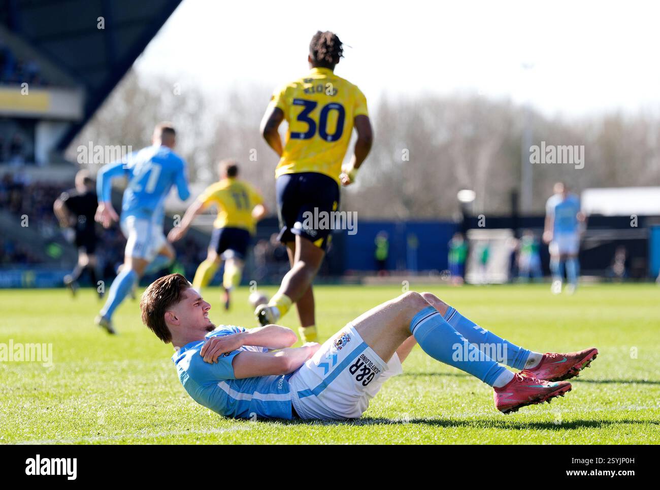 Coventry City's Jack Rudoni goes down injured after jostling for the ...
