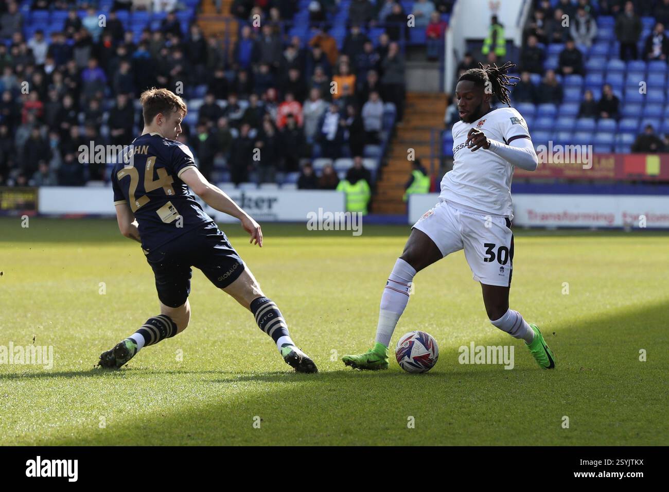 Omari Patrick of Tranmere Rovers looks to dribble past Kyle John or ...