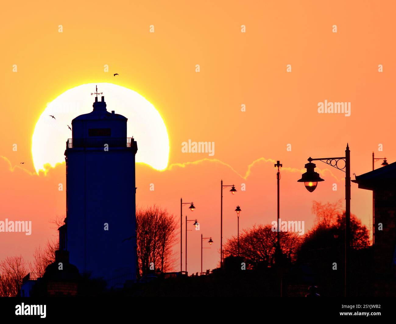North Shields Highlights lighthouse and street lamps at sunset with ...