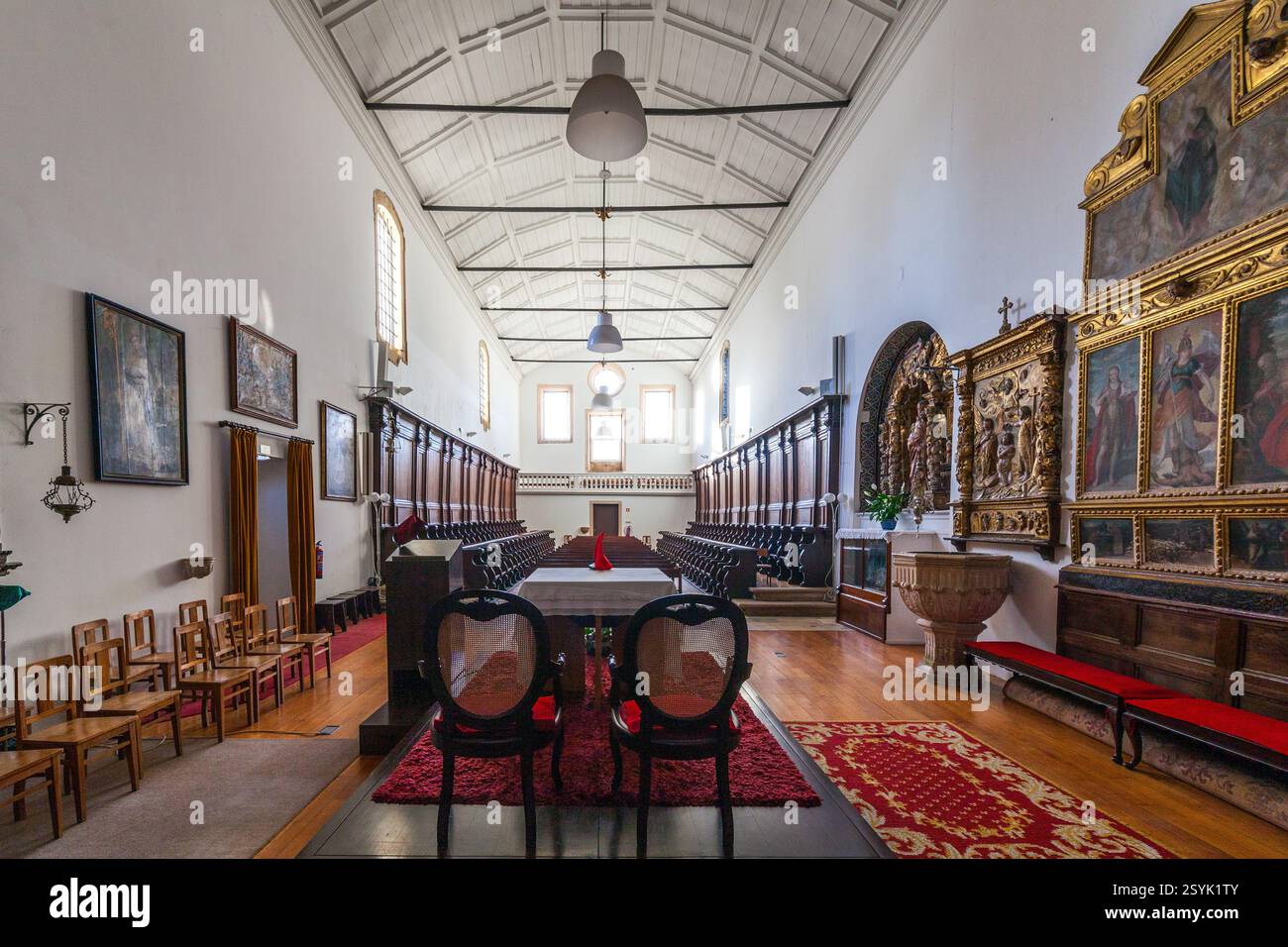 The interior of a historic church or monastery, featuring a long, high ...