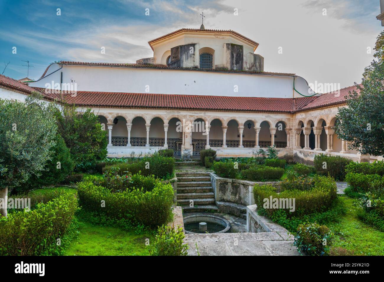 A historic monastery with a cloistered courtyard, featuring a central ...