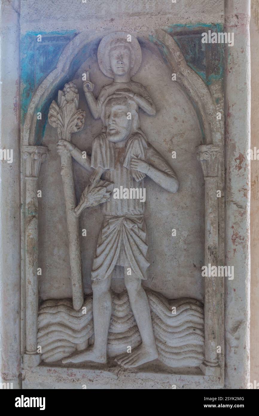 A stone relief depicting the Baptism of Christ, with John the Baptist ...