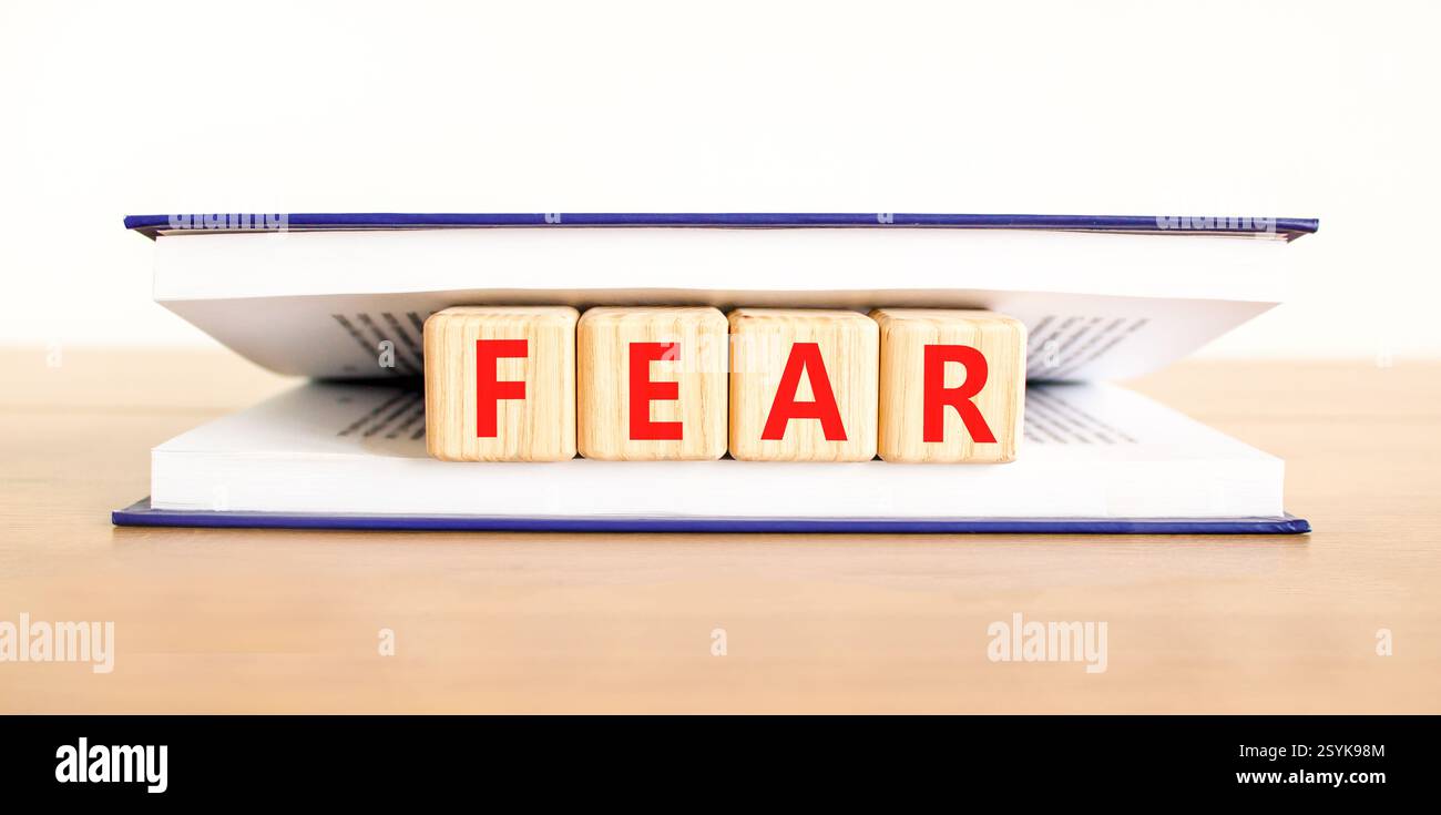Fear symbol. Concept word Fear on beautiful wooden blocks in book ...