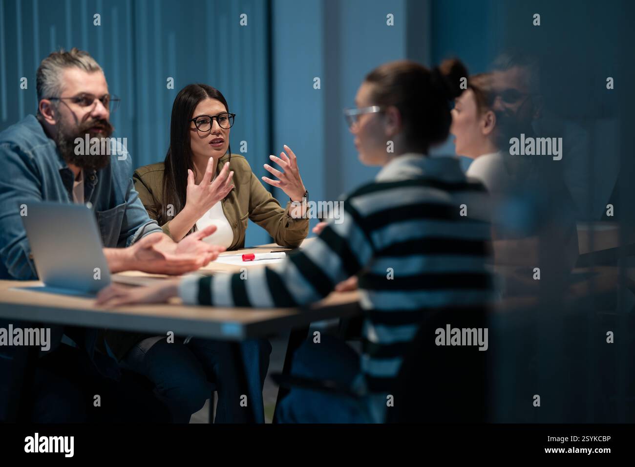 A diverse team of young professionals collaborates in a modern office ...