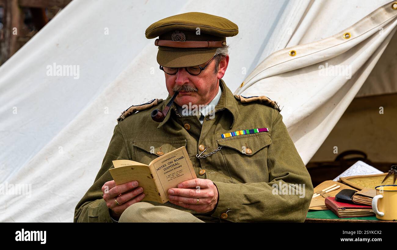 UK, June 2019: Man in vintage militray uniform, circa WW2, reading as ...