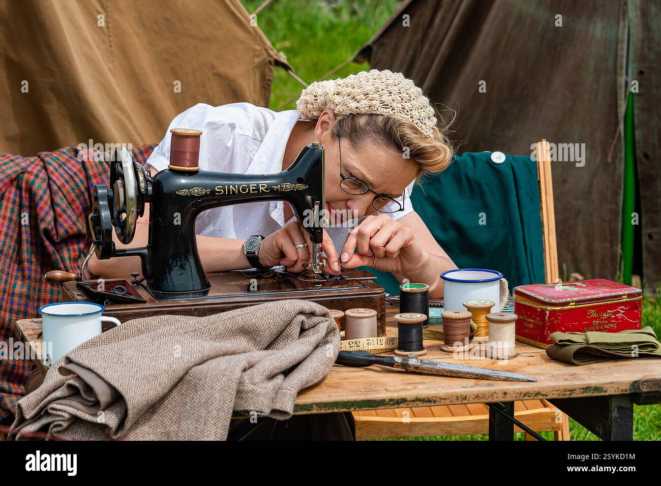 UK, June 2019: WW2-Era Woman Threading a Vintage Sewing Machine ...