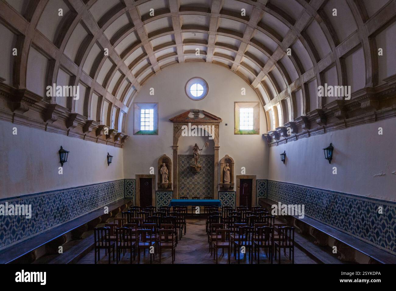 A historic church interior with a vaulted ceiling, rows of wooden pews ...