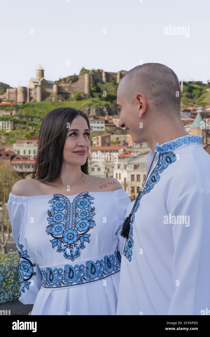 Engagement proposal in Tbilisi: Groom proposing to bride in traditional Ukrainian wedding attire ...