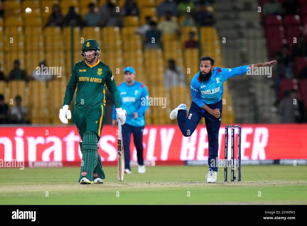 England's Adil Rashid, right, bowls as South Africa's Heinrich Klaasen ...