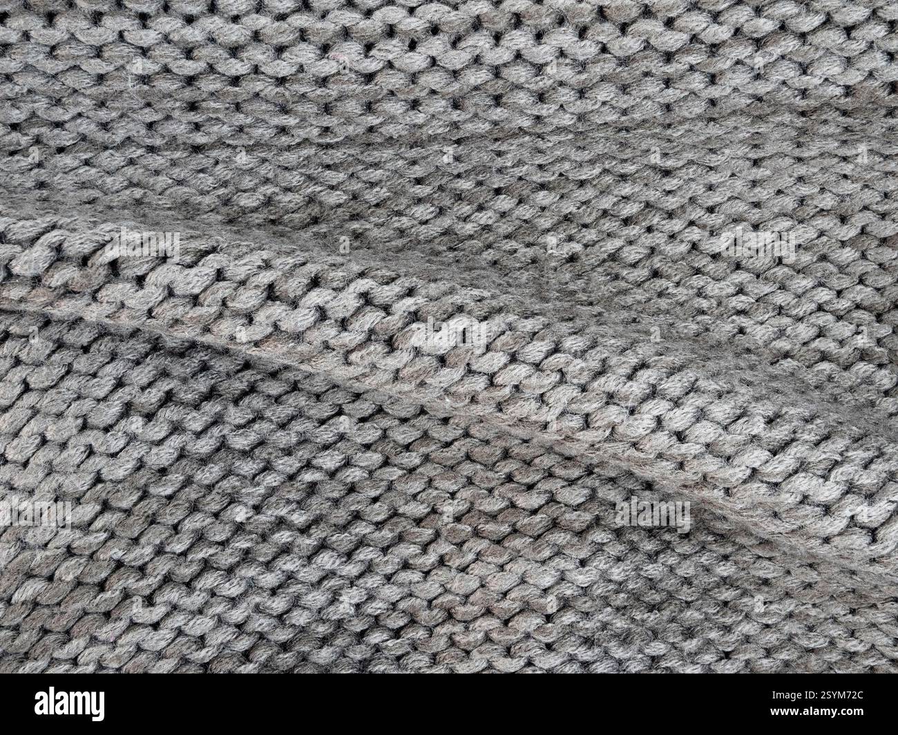 Soft gray knit fabric displays a cozy, warm texture with detailed ...