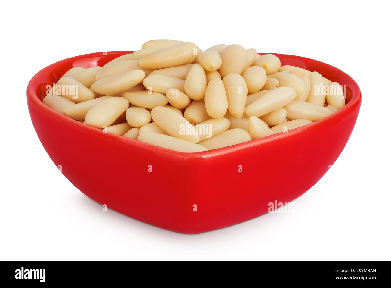 Shelled European pine nuts in ceramic bowl isolated on white background ...
