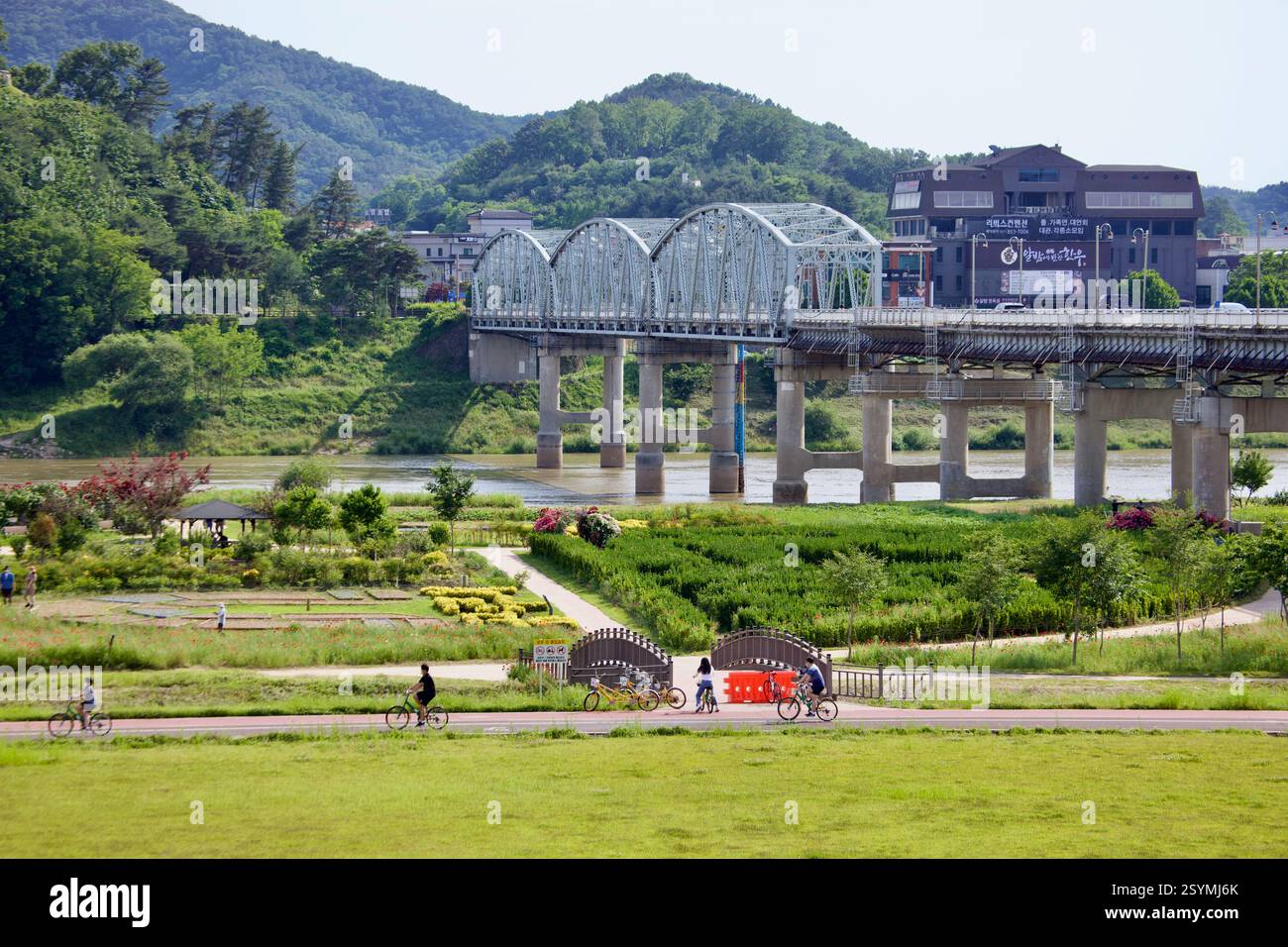 Gongju City, South Korea - May 27th, 2021: A steel truss bridge spans the Geum River, connecting ...