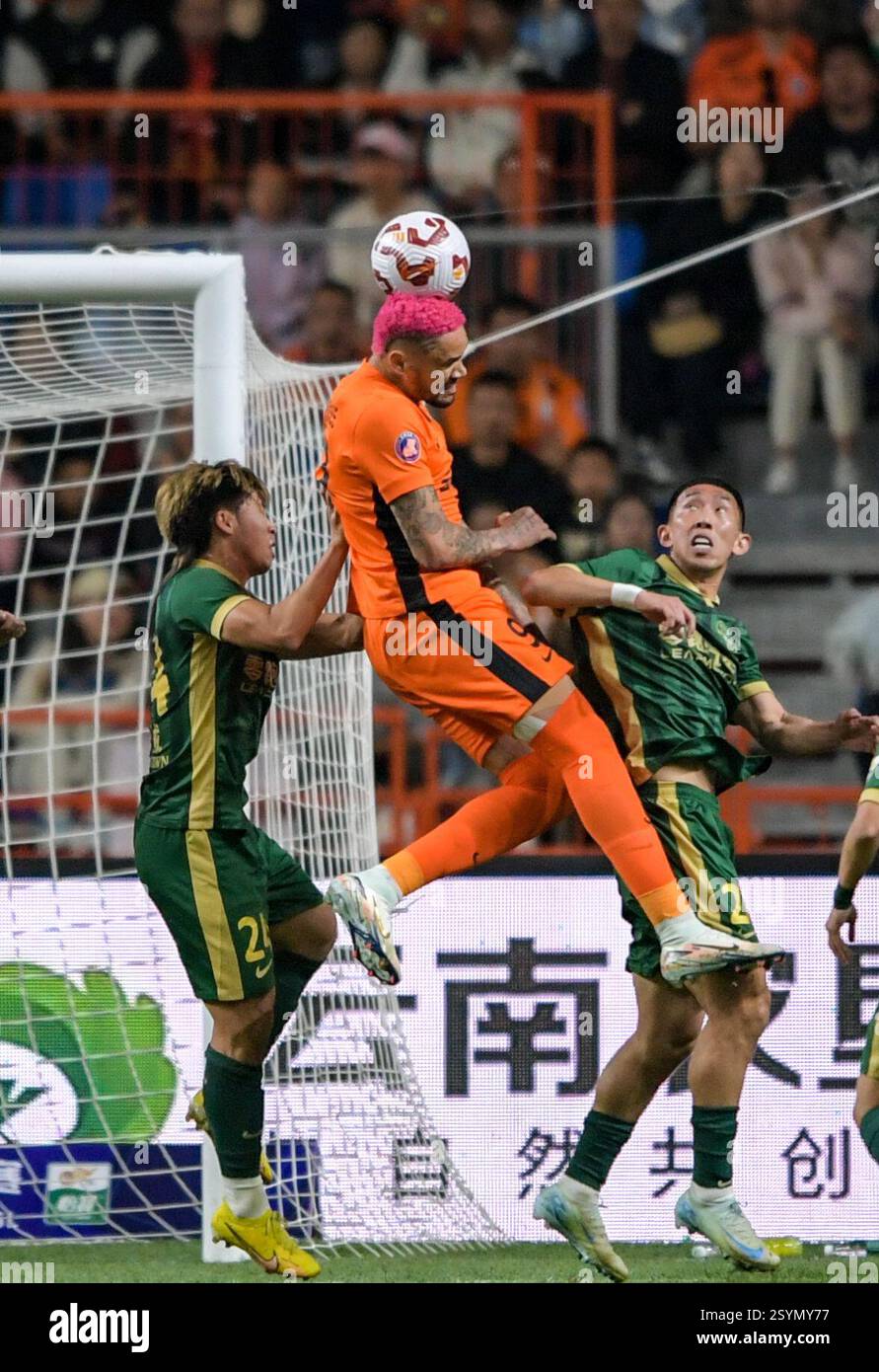 Yuxi, China's Yunnan Province. 1st Mar, 2025. Pedro Henrique (C) of Yunnan Yukun heads the ball ...