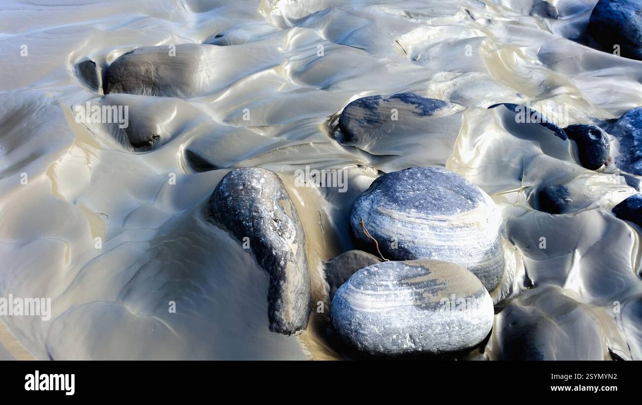Close up of rocks and layered clay on riverbed in morning. Rocks ...