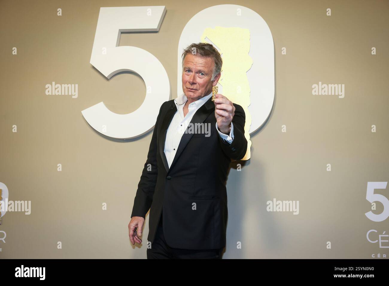 French actor Franck Dubosc poses after receiving a mini award during the 50th Cesar Awards ...