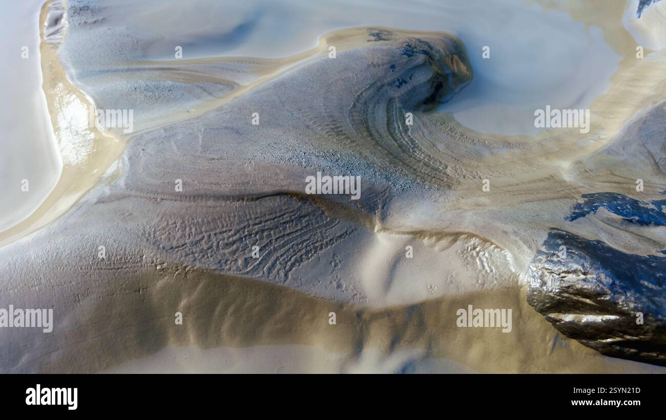 Close up of layered clay and clear river water in morning. Earth tone ...